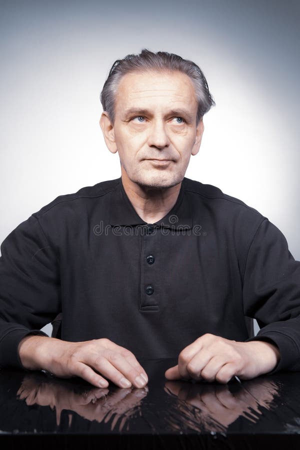 Aging Man Sitting by the Table and Posing for Portrait Stock Image ...