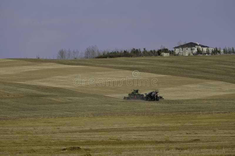 Agricultural Tractor in a Farm Field Preparing for Planting Stock Photo ...