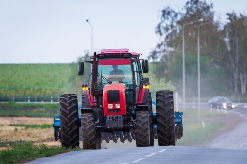 Agricultural Tractor Moving on the Asphalt Road after Working in Field ...