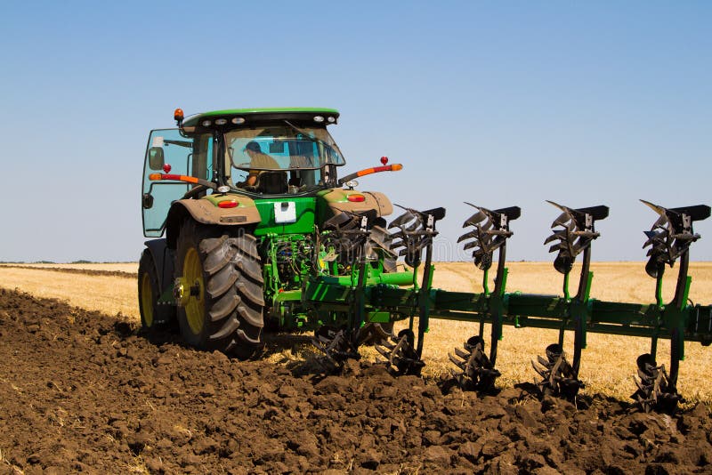 Agricultural Tractor Plowing a Field Editorial Stock Photo - Image of ...