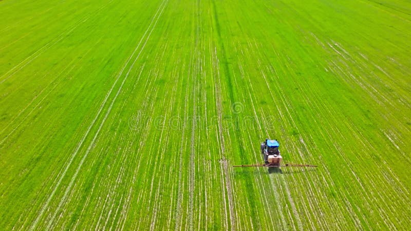 Agricultural Tractor Spraying Chemicals on Green Field, Full-frame ... Agricultural Tractor Spraying Chemicals on Green Field, Full-frame ...