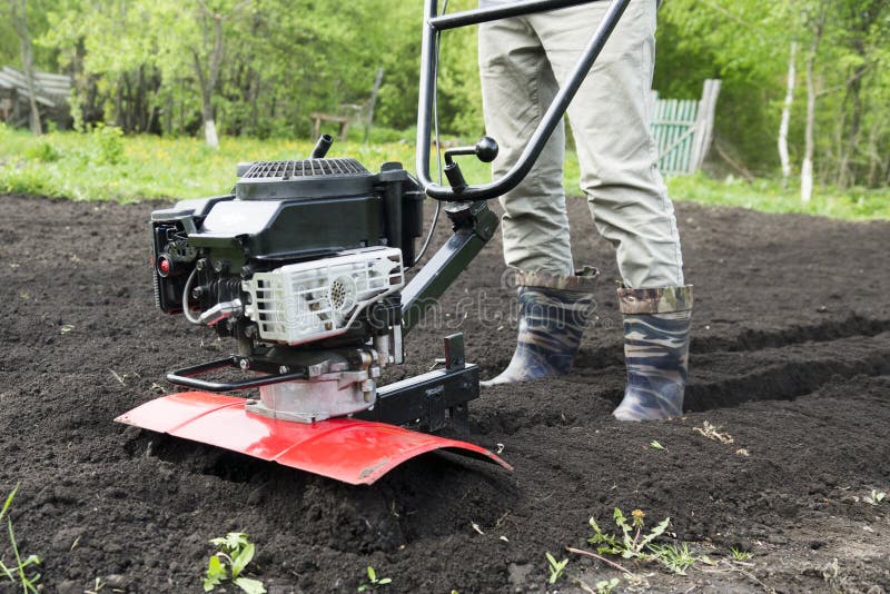 The Man is Engaged in Agricultural Work, Works the Soil Stock Photo ...