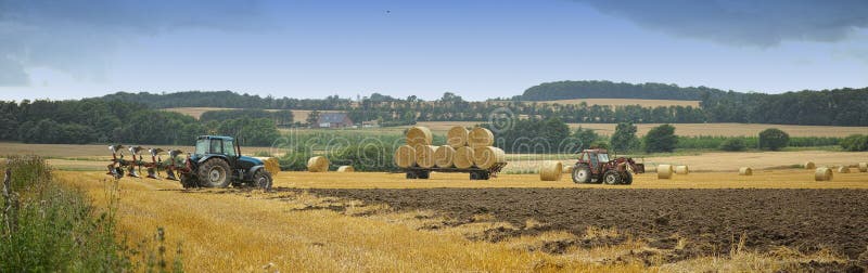 Agriculture in Action. Tractors and Hay on a Farm. Stock Photo - Image ...