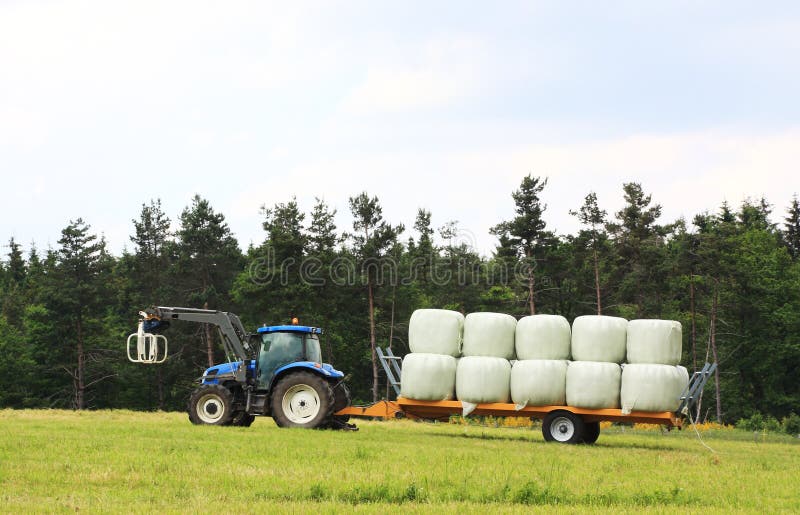 Agriculture - Loading Hay Bales Stock Photo - Image of farm, baled ...