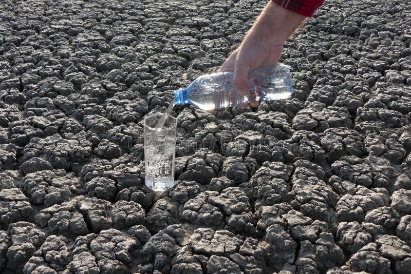 Agua Al Vidrio Que Vierte En La Tierra Seca Imagen de archivo - Imagen ...