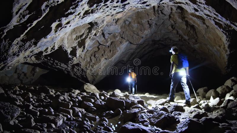 AI Explorers with Flashlights in a Cave Stock Footage - Video of earth ...