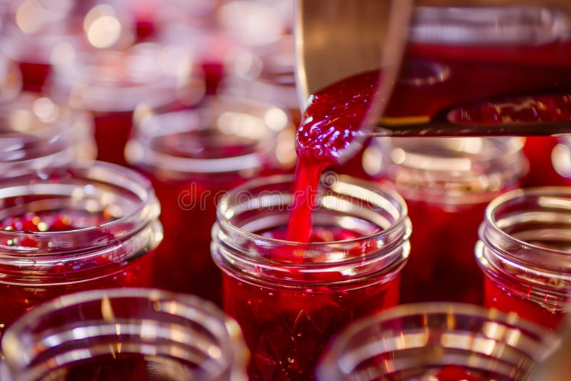 AI Generated Illustration of Jam Being Poured into Jars with a Spoon on ...