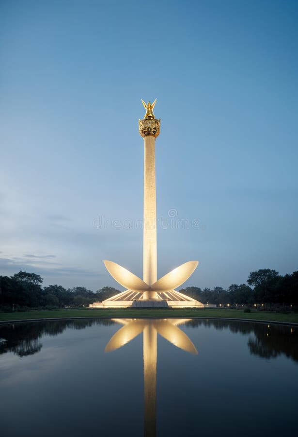 The Monas Monument is Lit Up at Night with a Large Statue Stock ...