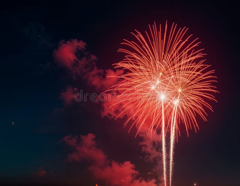 Red Illuminated Fireworks are Being Released on a Clear Dark Sky Stock ...
