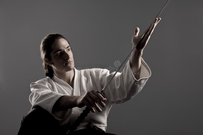 Aikido Man Looking at Katana(sword) Stock Photo - Image of person ...
