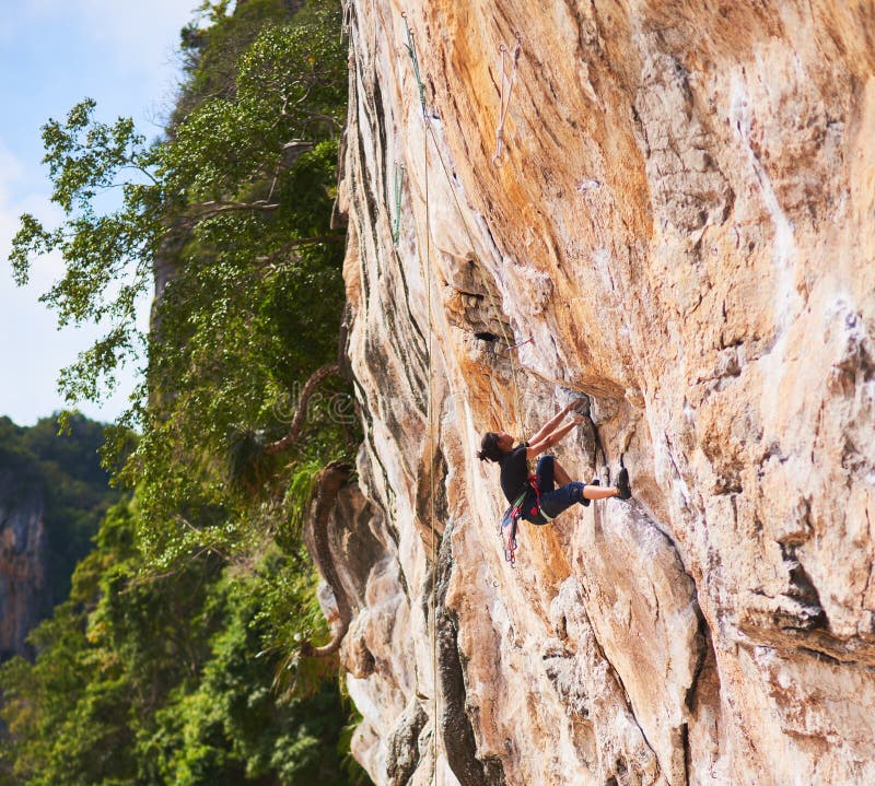 Aim for Greater Heights. a Young Rock Climber Scaling a Cliff Face ...