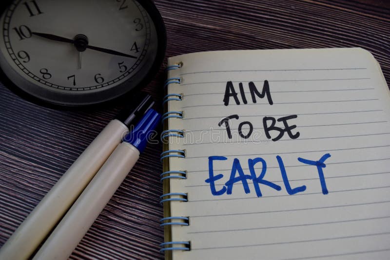 Aim To Be Early Write on a Book Isolated on the Table Stock Image ...