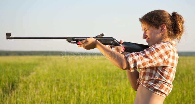 Girl with a Gun for Trap Shooting Aiming at a Target Stock Photo ...