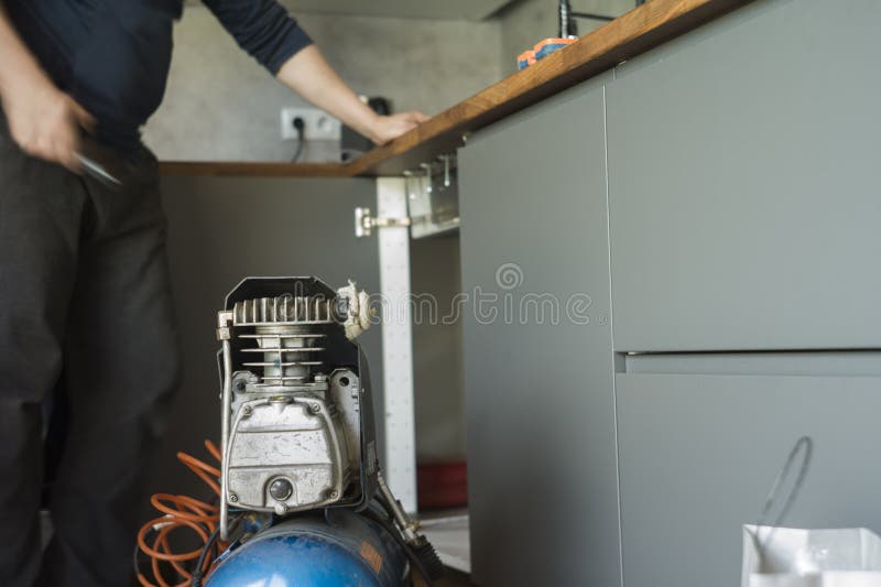 Plumber on the kitchen. stock image. Image of clogged - 59609307