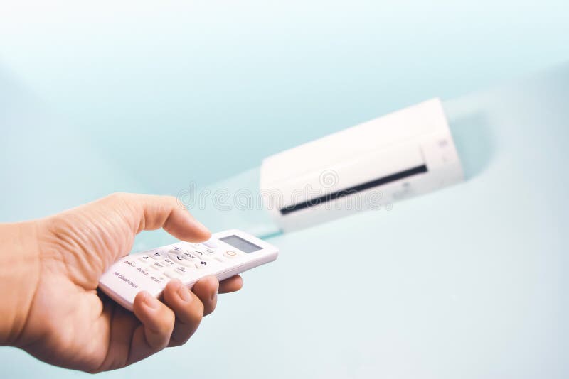 The Air Conditioner Remote Control is Pressed by a Human Hand Stock ...