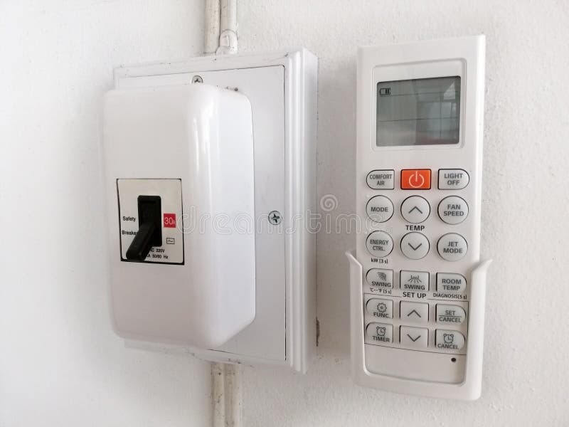 Air Conditioner Remote Control and Switch Breaker on the Wall Stock ...
