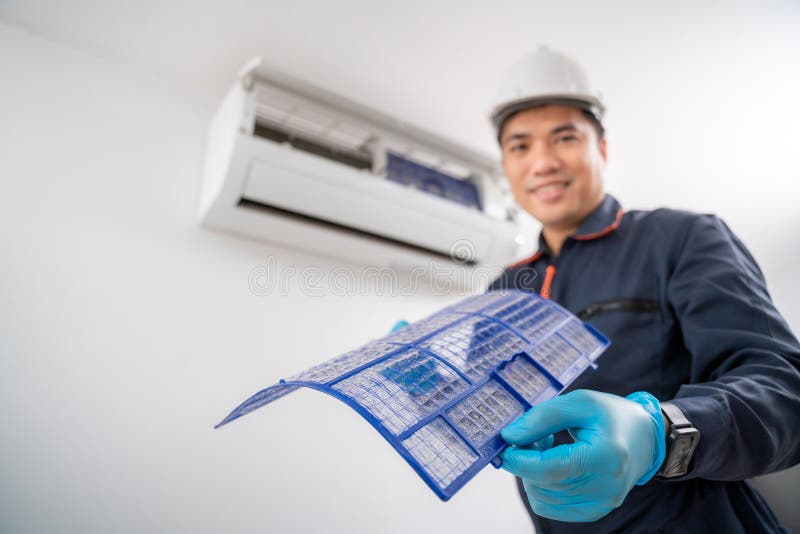 Air Conditioner Technician Removes the Air Conditioner Filter and Shows ...