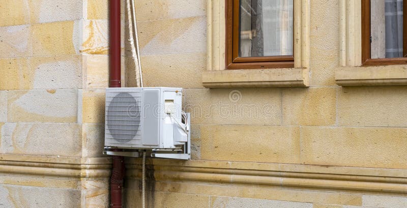 Air Conditioning Unit Mounted on Exterior Wall of a Building in Urban ...