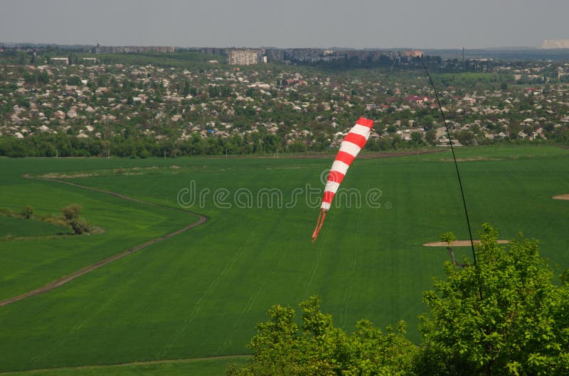 Air Field Direction Sign and a Wind Force Windsock Against the Blue Sky ...