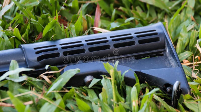 Air Soft Gun Collapsible Stack Put on the Grass Stock Photo - Image of ...