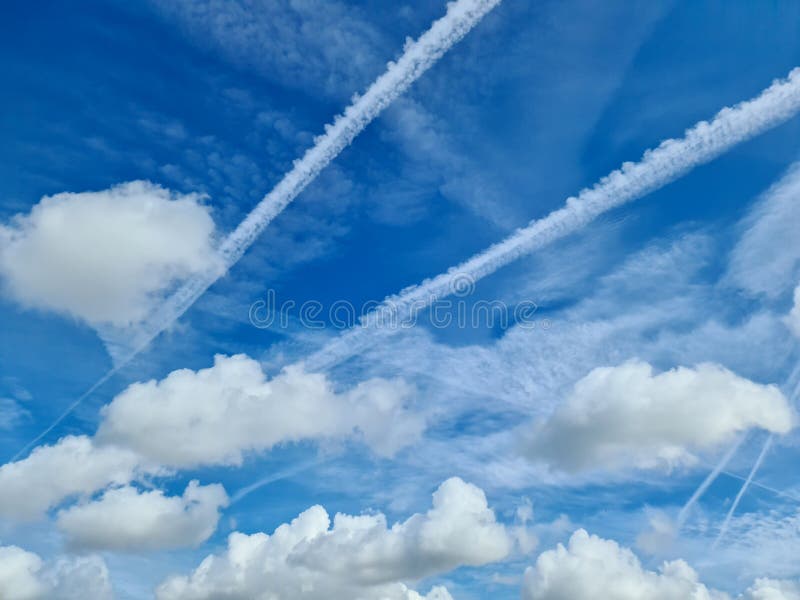 Aircraft Condensation Contrails in the Blue Sky Inbetween Some Clouds ...