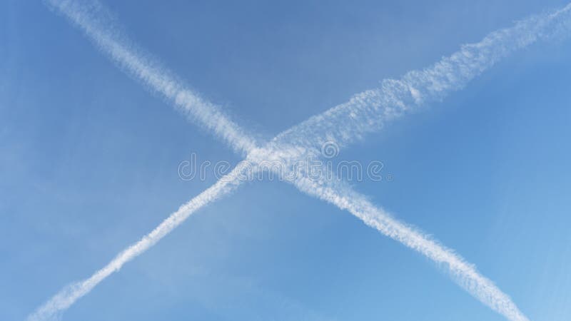 Aircraft Contrails Crossing and Forming an X in a Blue Sky Stock Image ...