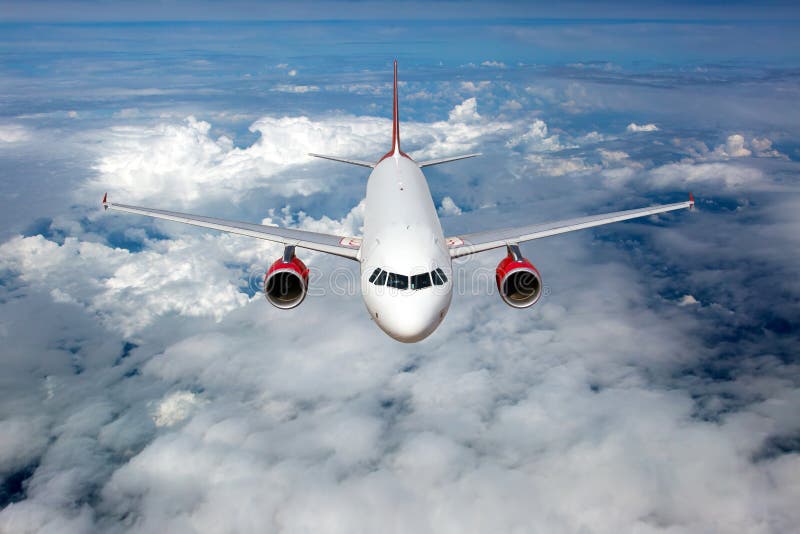 Passenger Plane Flies High Above the Clouds. Front View Stock Image ...