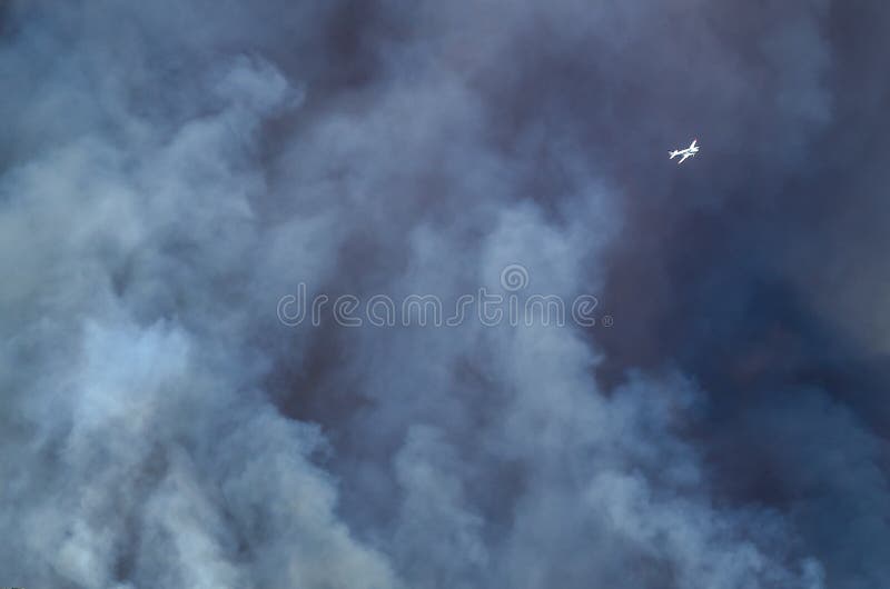 Aircraft Flying Ahead of the Dense White Smoke Rising from the Raging ...
