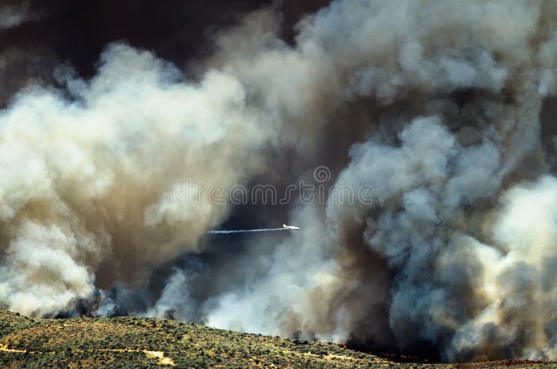 Aircraft Flying through the Dense White Smoke Rising from the Raging ...
