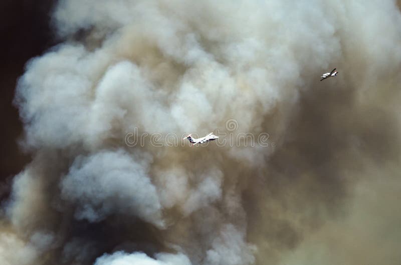Aircraft Flying through the Dense White Smoke Rising from the Raging ...