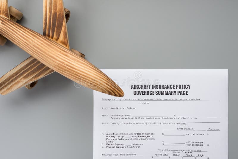 Aircraft Insurance Policy Coverage Summary and an Airplane Model Close ...