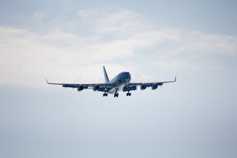 The aircraft is landing stock photo. Image of space, airliner - 92775578