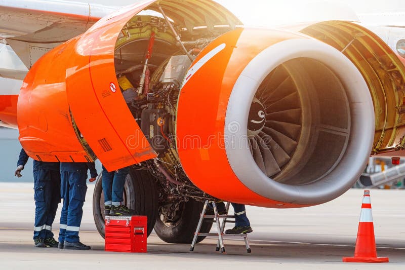 Aircraft Maintenance Mechanics Inspecting and Working on Airplane Jet ...
