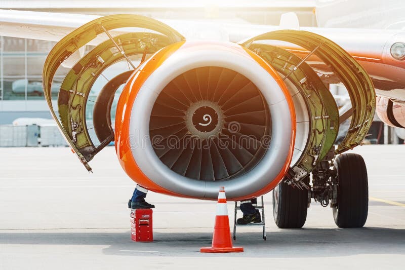 Aircraft Maintenance Mechanics Inspecting and Working on Airplane Jet ...