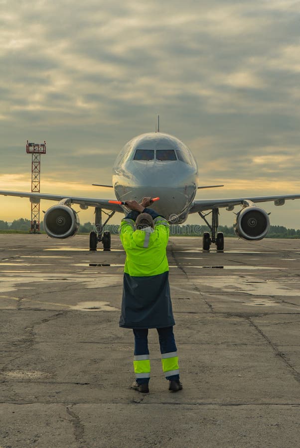 Aircraft Maintenance Worker Standing in Front of the Airplane at the ...