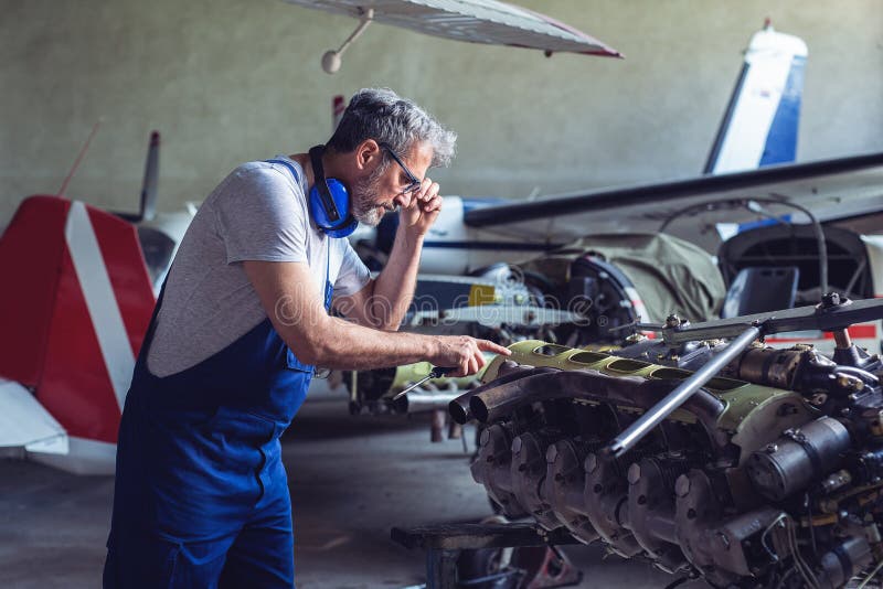 Aircraft Mechanic Repairing Jet Engine Stock Photo - Image of airport ...