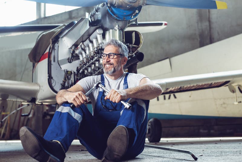 Aircraft Mechanic Repairs an Aircraft Engine in an Airport Hangar Stock ...