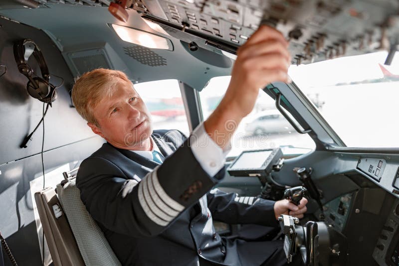 Aircraft Pilot Checking Overhead Panel before the Flight Stock Photo ...