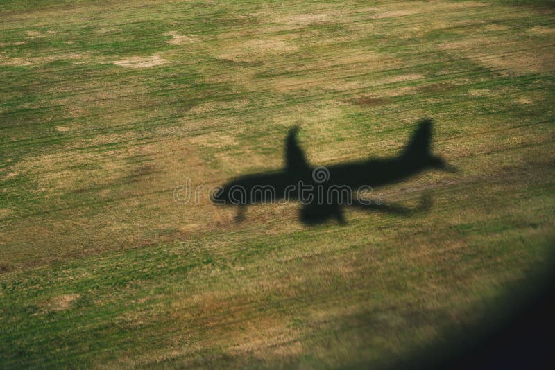 Aircraft Shadow after Takeoff on Ground Over Airport Runway with Green ...
