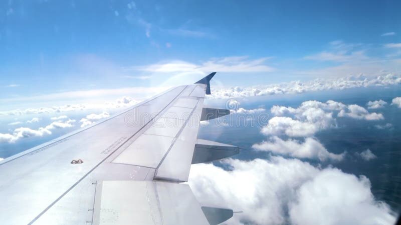 Aircraft Wing and Blue Sky with White Clouds during a Flight Stock ...