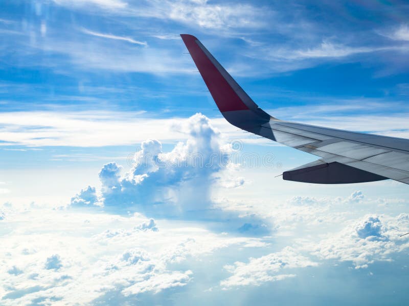 Airplane Wing Over Blue Sky and White Cloud View Looking through ...