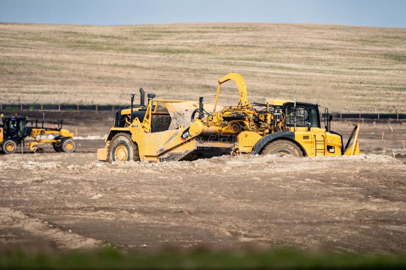 Wheel Tractor Scraper at Work on a Construction Site Developing Land ...