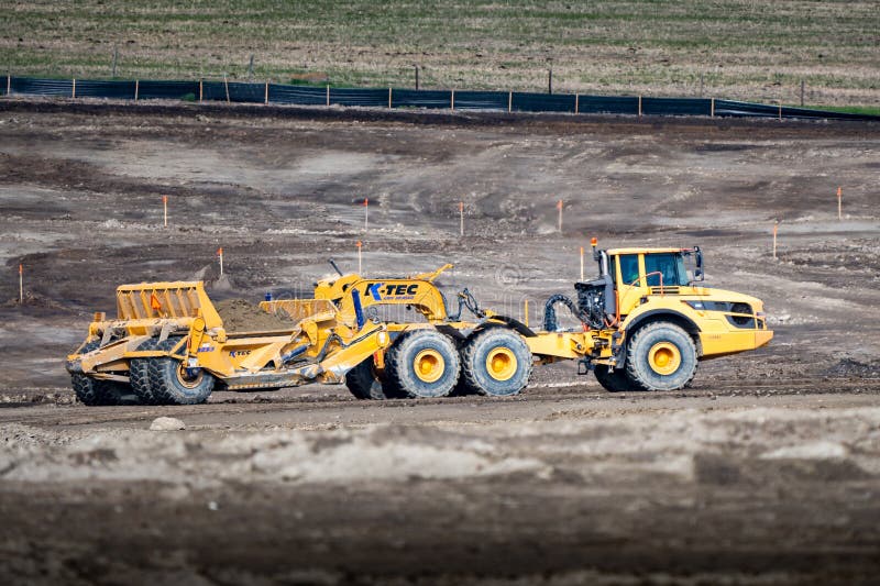 Wheeled Scraper Working on Developed Land Constructing a New Community ...