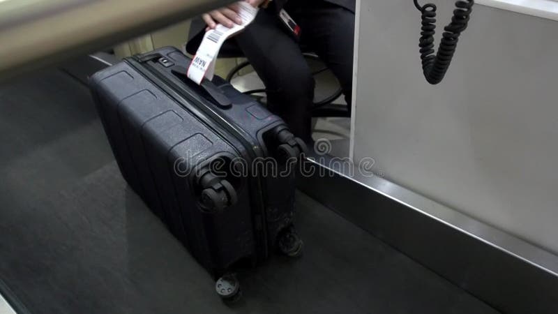 Airline Ground Staff Attach Check in Baggage Tag on Trolley Bag at ...