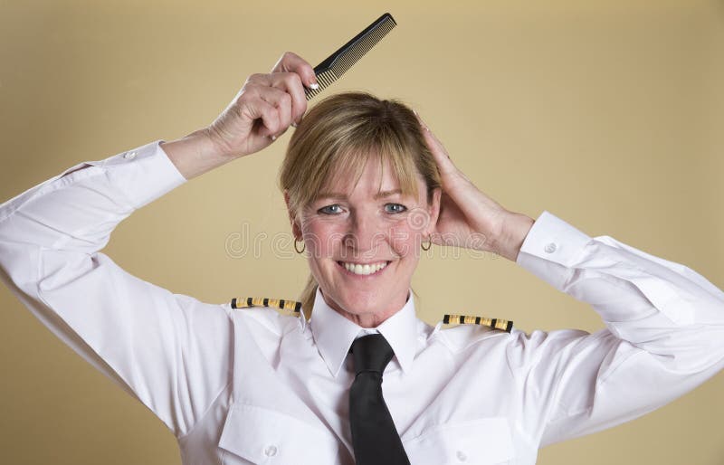 Airline Pilot Combing Her Hair Stock Image - Image of gold, expression ...