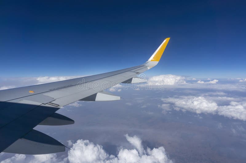 Airliner Flying Over Clouds and Landscape Stock Photo - Image of ...