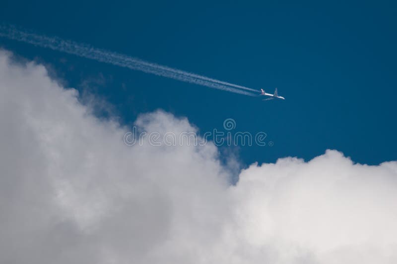 Airliner Flying Over White Cumulus in Blue Sky Stock Photo - Image of ...