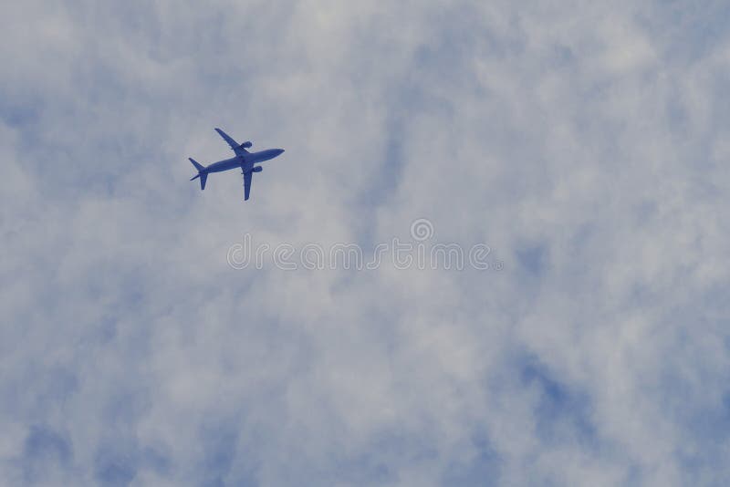 Airplane in the Blue Sky with Clouds, Bottom View Stock Photo - Image ...