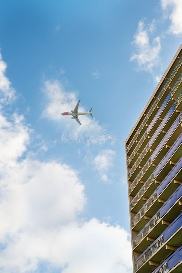 Airplane in Blue Sky with Light Clouds Over the House Editorial Photo ...
