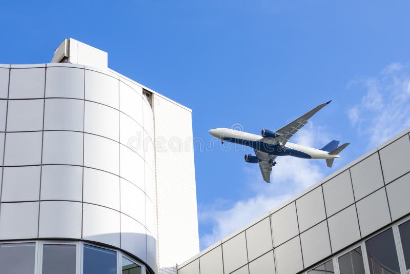 Airplane in Blue Sky with Light Clouds Over the House Stock Image ...